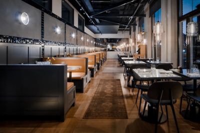 Guests Enjoy Meal Under Modern Restaurant Pendant Lighting in Sweden